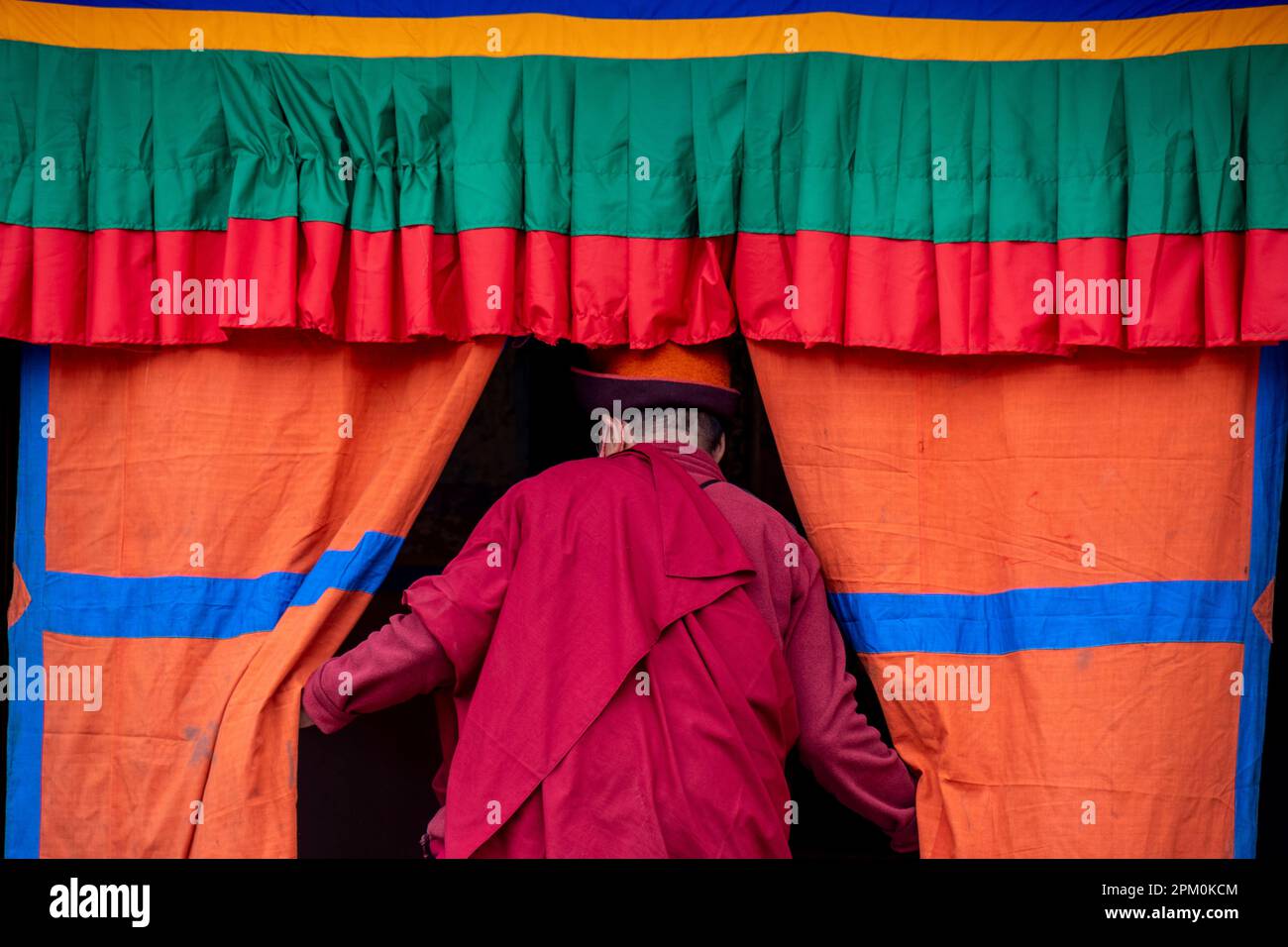 A Monk enters the Prayer Hall at Stongdey Monastery, Zanskar, Ladakh ...