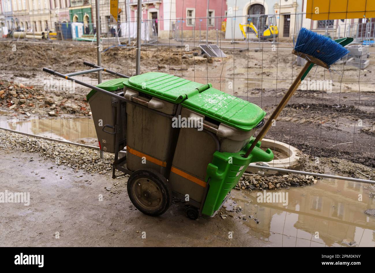 Green trolley container for street cleaning, stands near the ...
