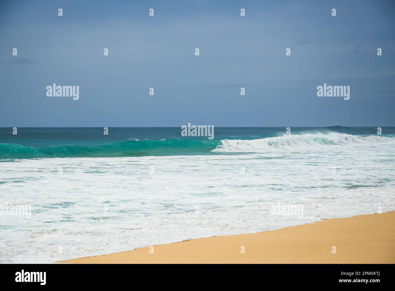 Low angle view of waves washing up onto tropical sandy beach Stock ...