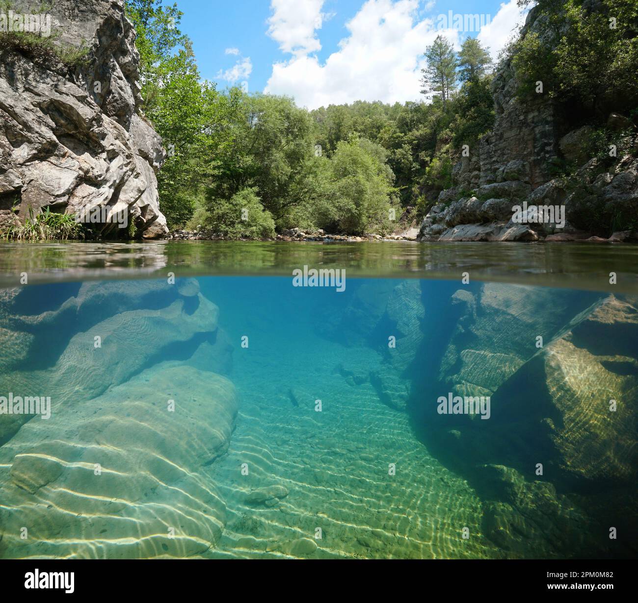 River with rocky riverbank over and under water surface, split level ...