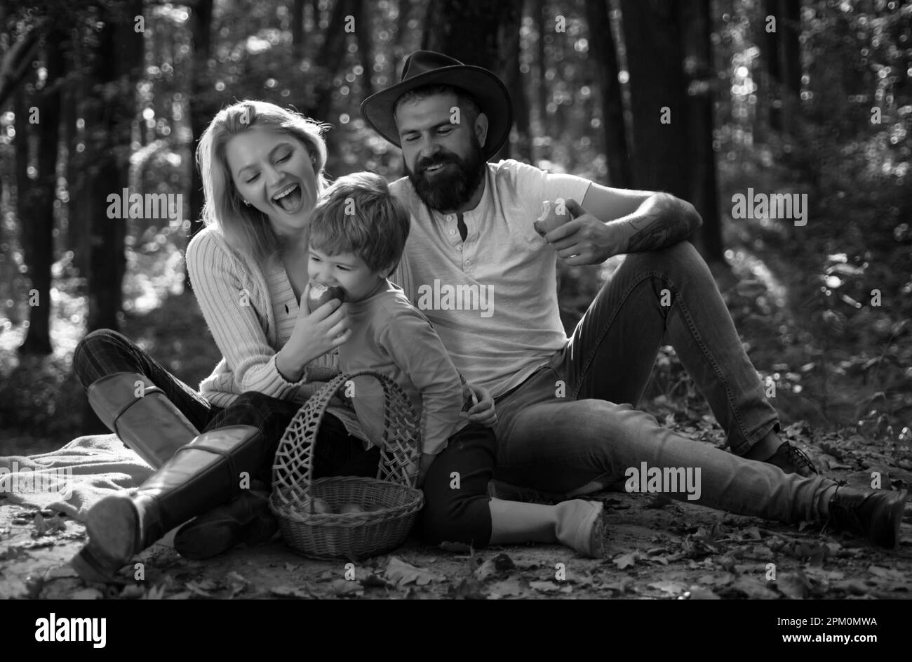 Snack time. Happy family with kid boy relaxing while hiking in forest ...