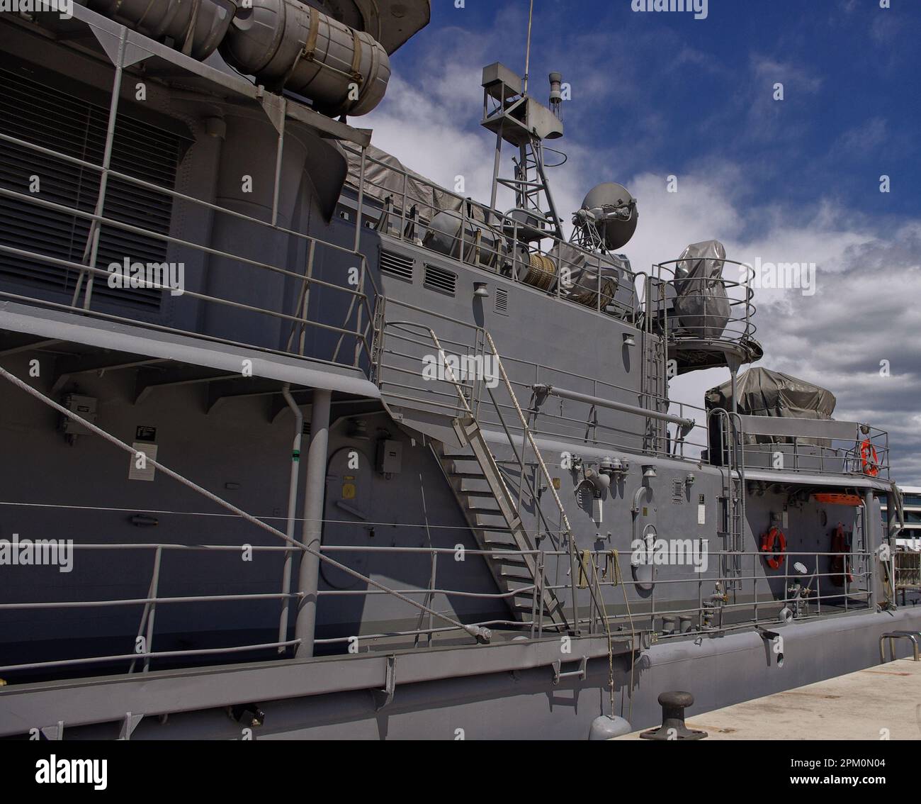 Side view of docked warship and refueling Stock Photo - Alamy