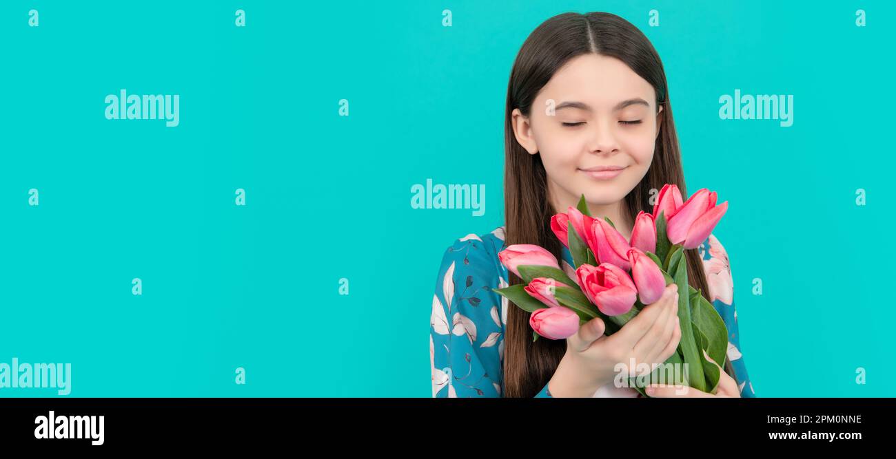 kid hold flowers for 8 of march. teen girl with spring bouquet on blue ...