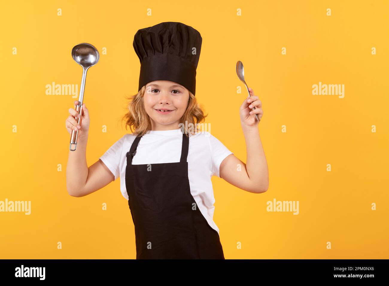 Funny kid chef cook with kitchen ladle and spoon, studio portrait. Chef ...
