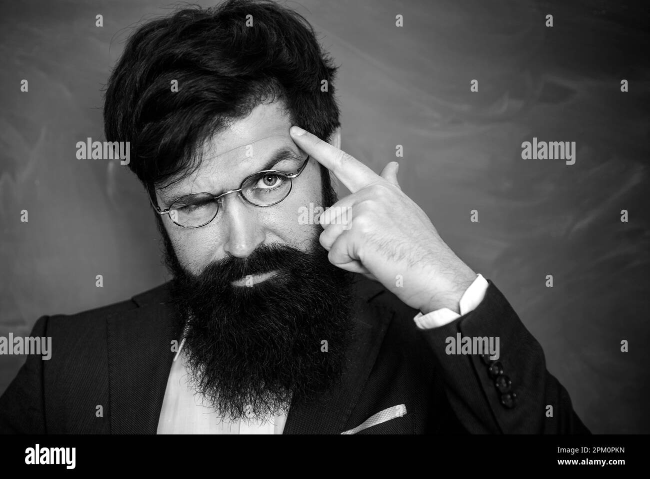 Professor in class on blackboard background. Young teacher near ...