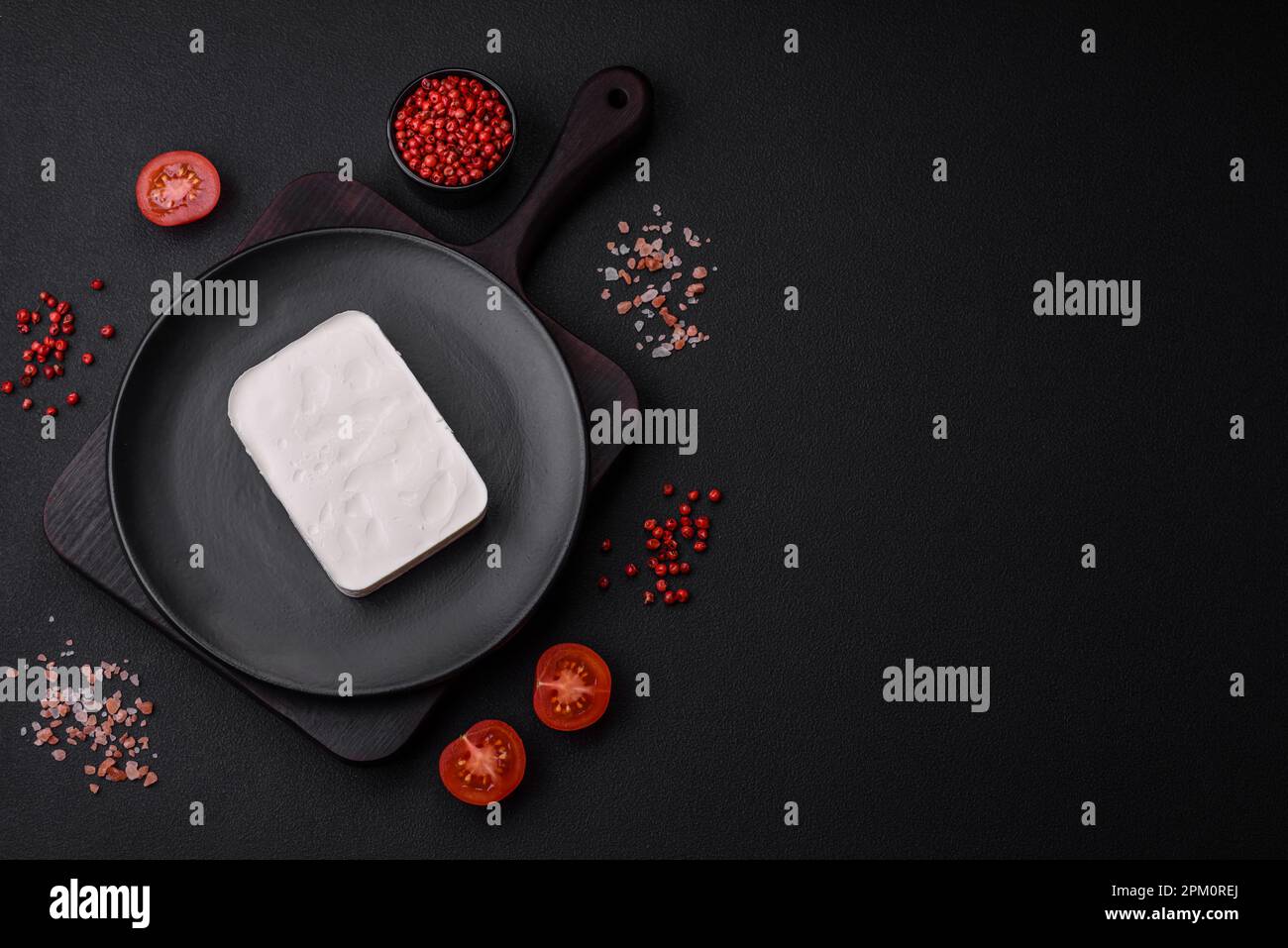 Delicious fresh rectangular shaped feta cheese with spices and ...
