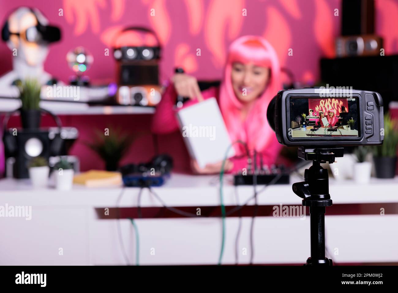 Asian vlogger filming white box review in recording studio talking with ...