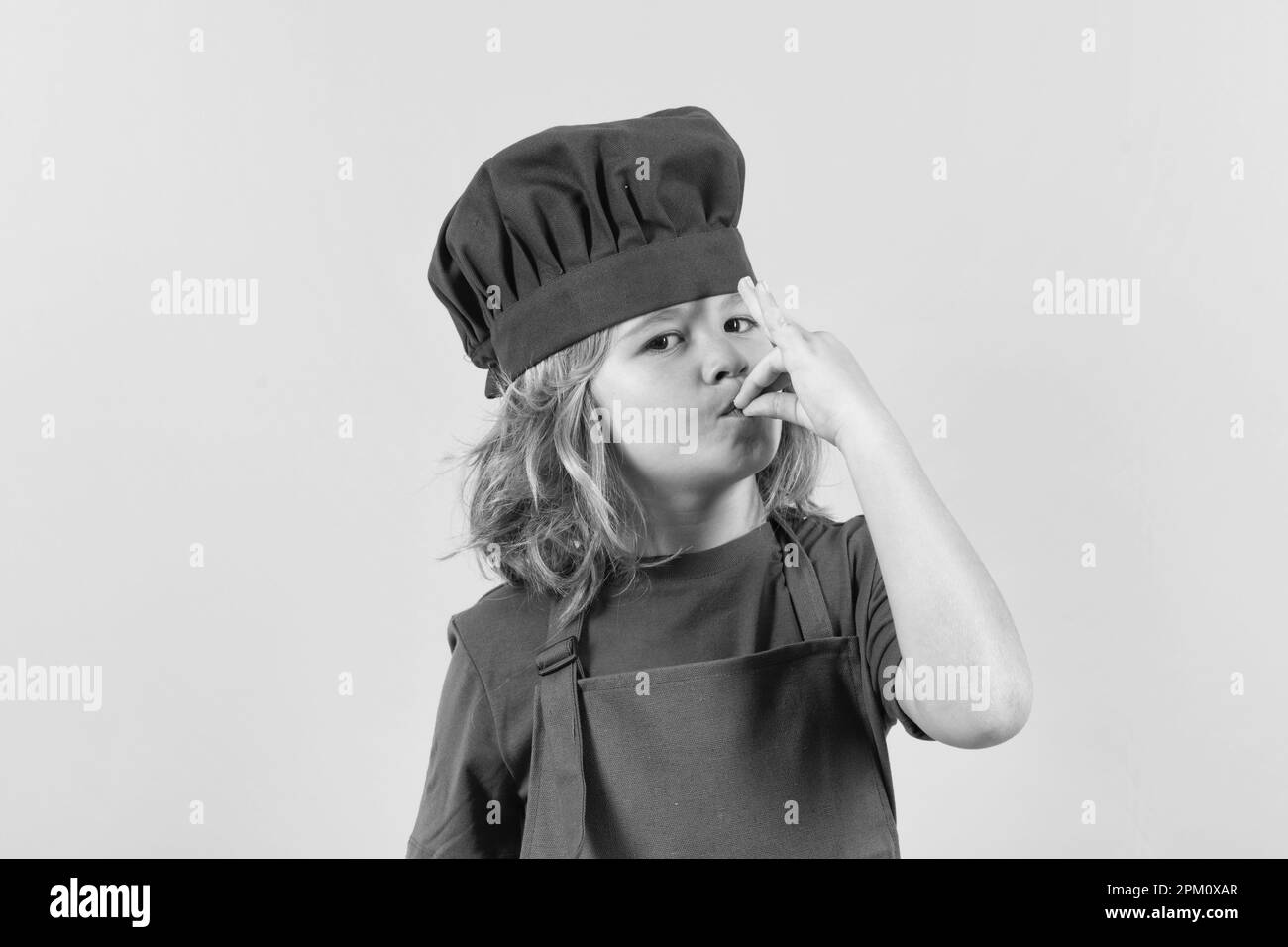 Funny kid chef cook studio portrait. Child wearing cooker uniform and ...
