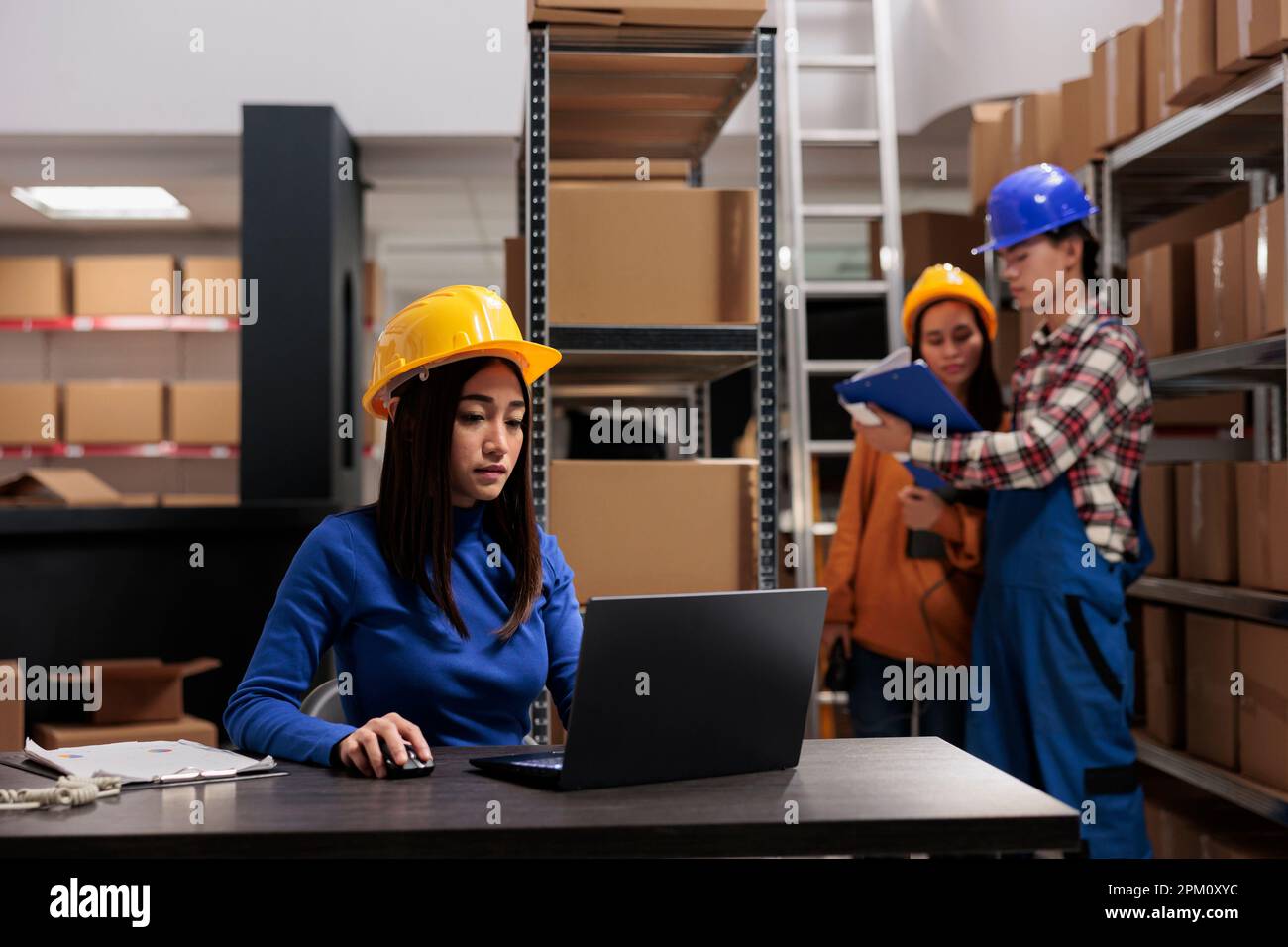 Retail storehouse young asian employee processing online order on ...