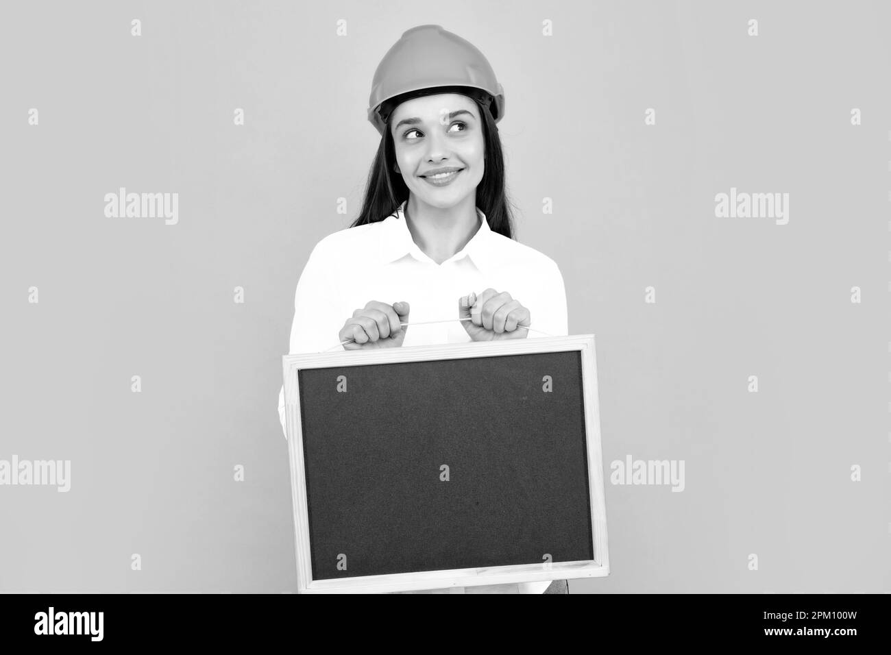 Smiling business builder woman with board, portrait on gray. Woman ...