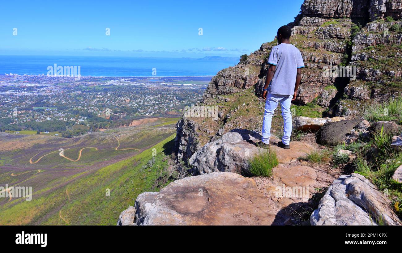African man standing in a mountain looking a beautiful landscape Stock ...