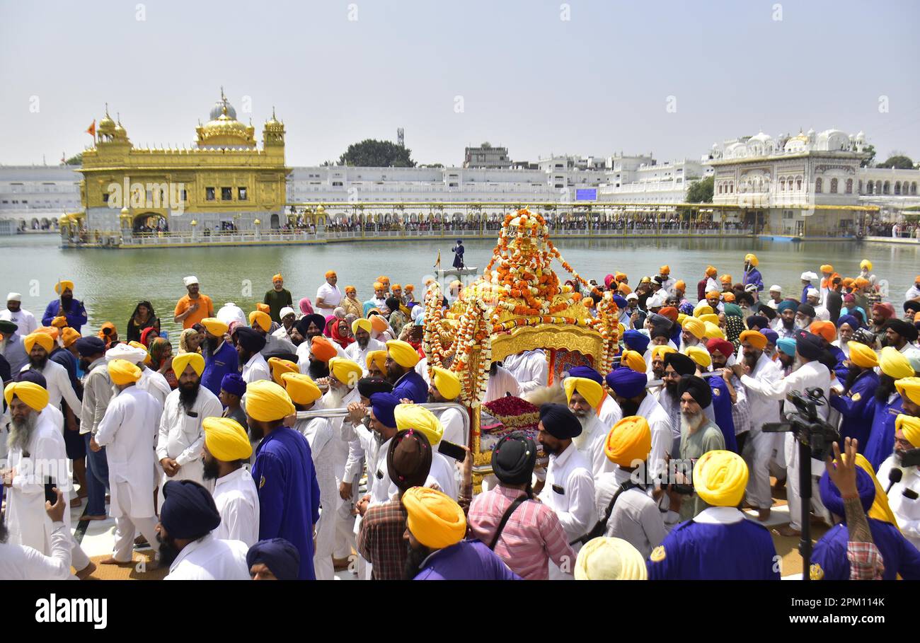 Amritsar, India. 10th Apr, 2023. AMRITSAR, INDIA - APRIL 10: Sikh devotees carry the Guru Granth ...