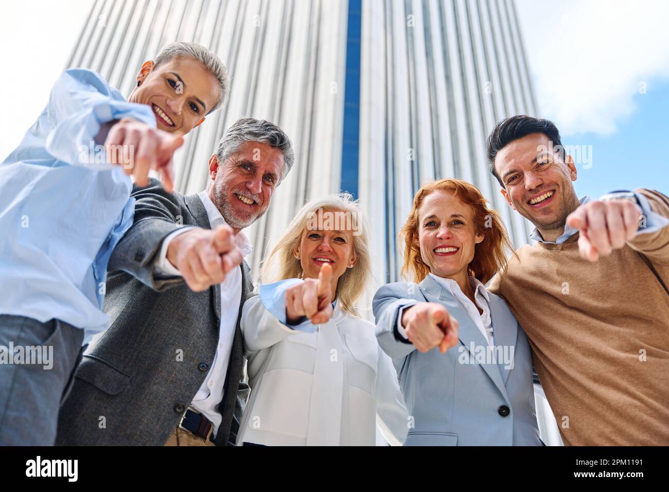 Low angle portrait of business people pointing ahead Stock Photo - Alamy