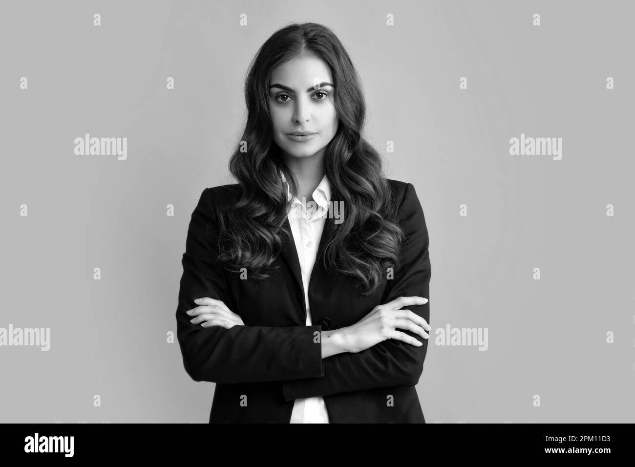 Portrait of successful business woman in suit on gray isolated ...
