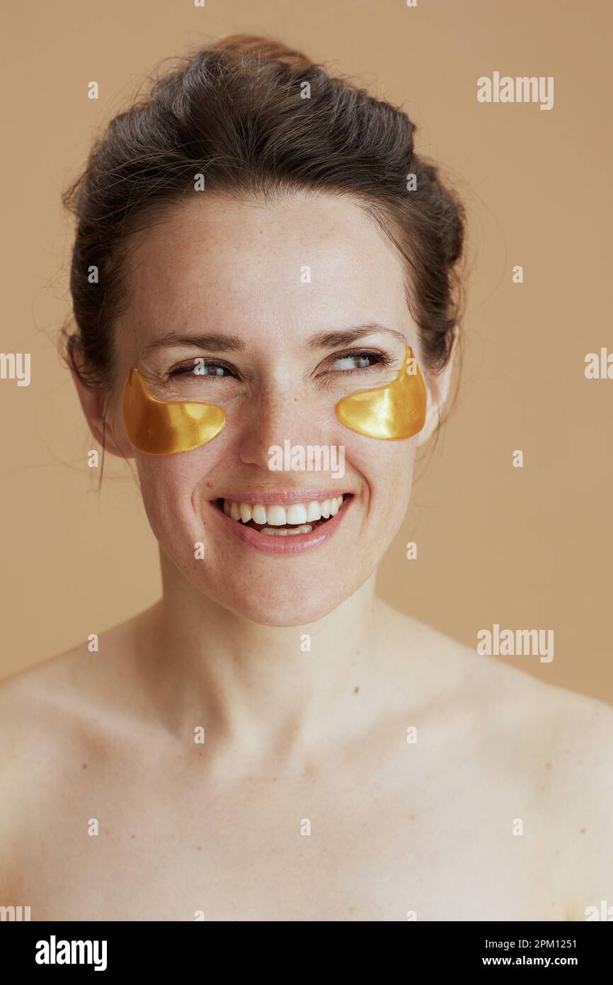 happy modern female with eye patches isolated on beige background Stock ...