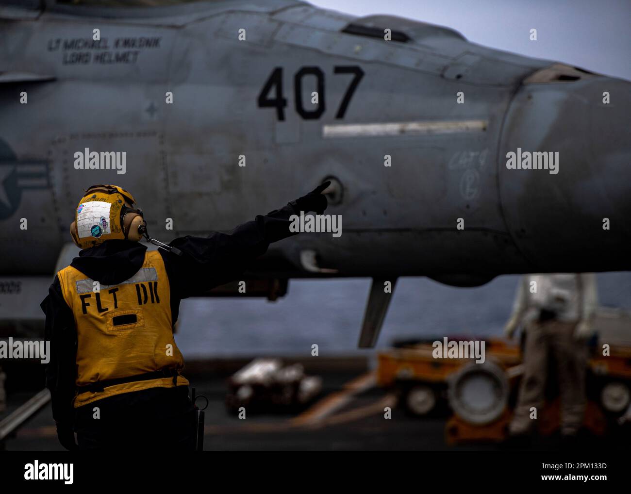230408-N-MH015-1060 PHILIPPINE SEA (April 8, 2023) A U.S. Navy Sailor directs an F/A-18E Super ...