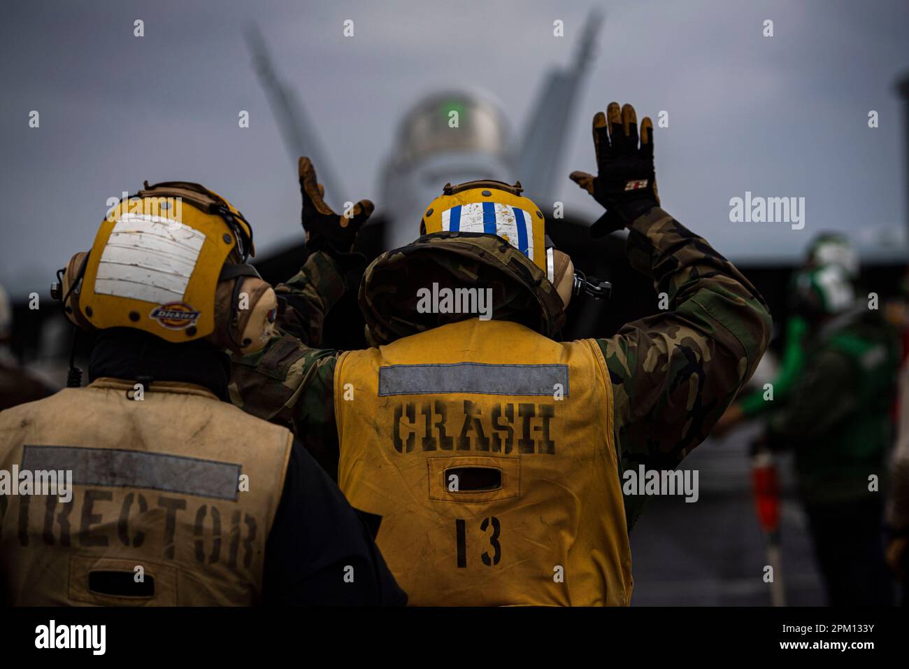 230408-N-MH015-1072 PHILIPPINE SEA (April 8, 2023) A U.S. Navy Sailor directs an aircraft onto a ...