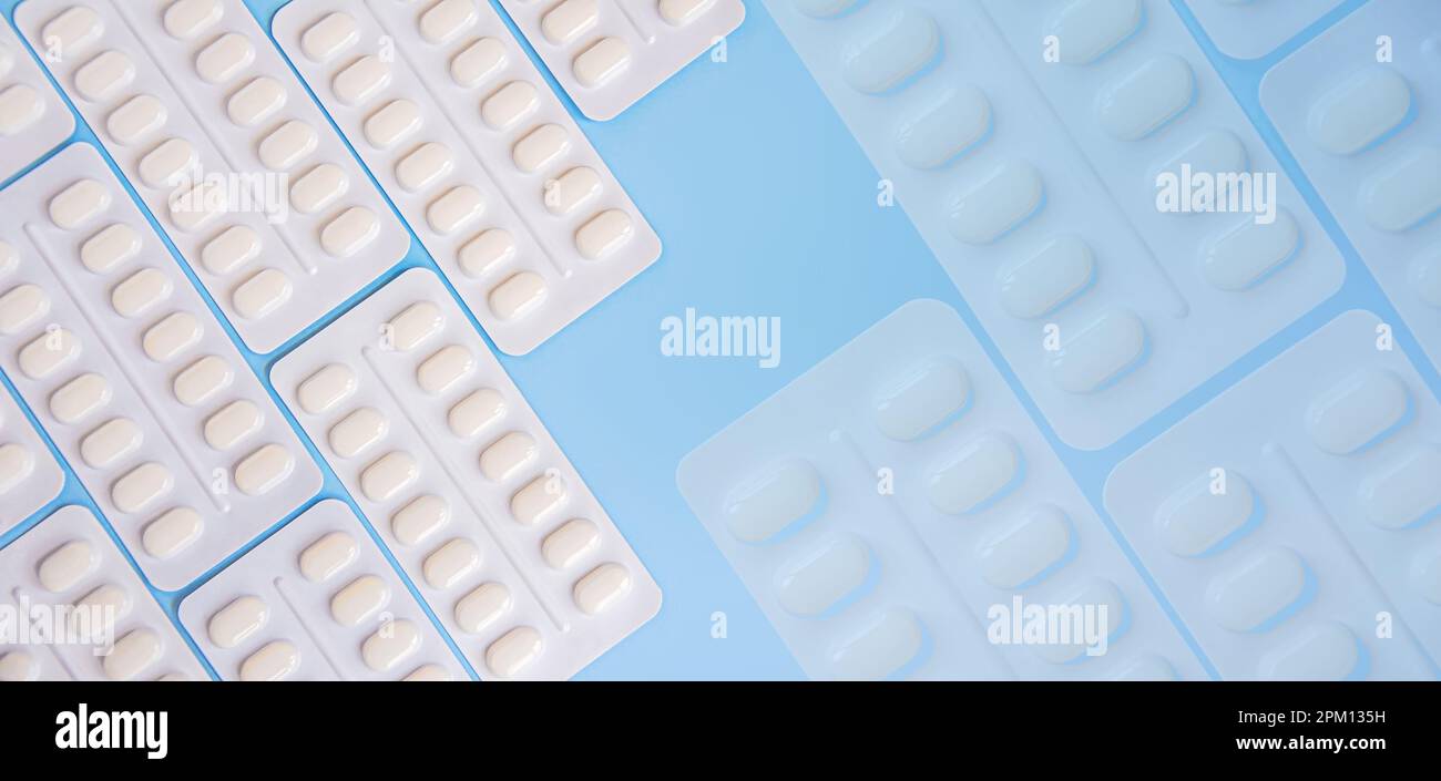Pharmaceutical medication and medicine pills in packs on blue ...