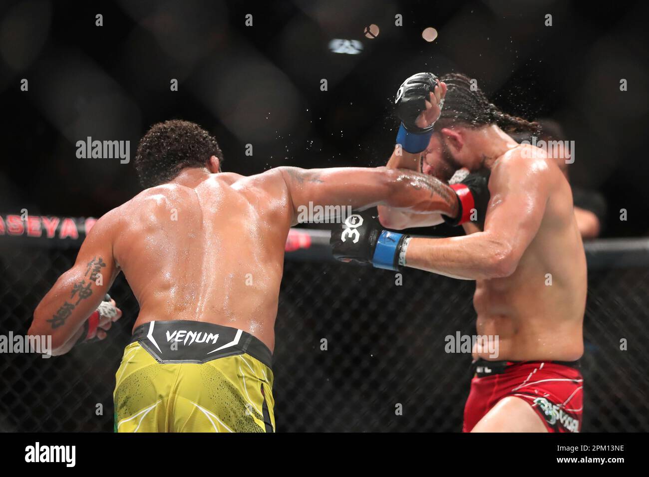 MIAMI, FLORIDA - APRIL 8: (L-R) Gilbert Burns punches Jorge Masvidal in ...
