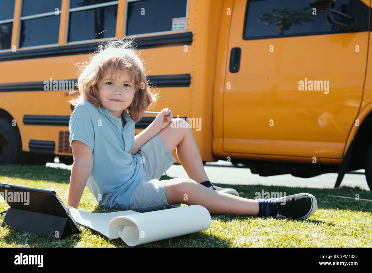 Back to school. Happy child study in park near school bus. Schoolboy ...
