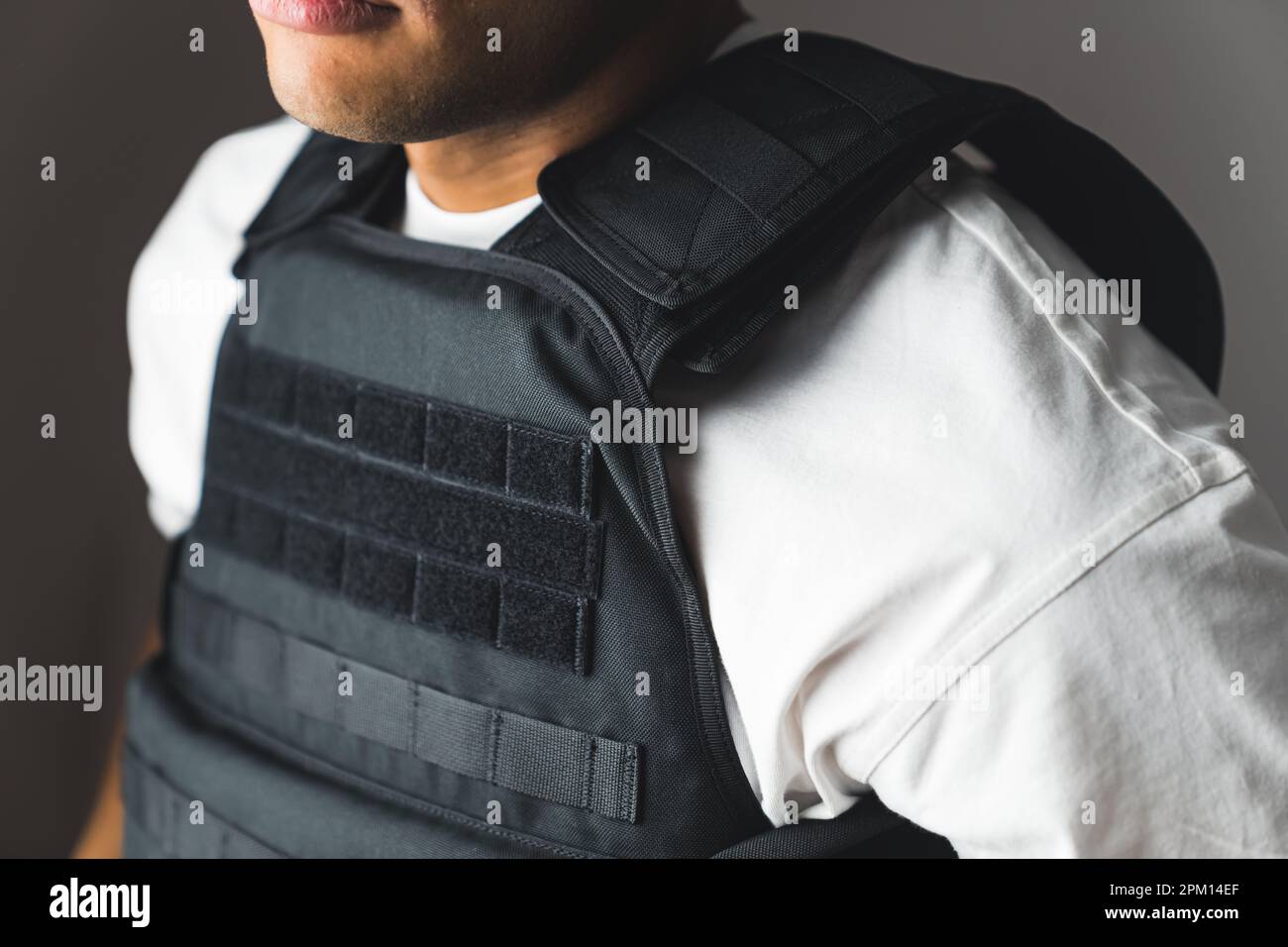Close up of black bullet proof vest, body armor on man body. No face ...