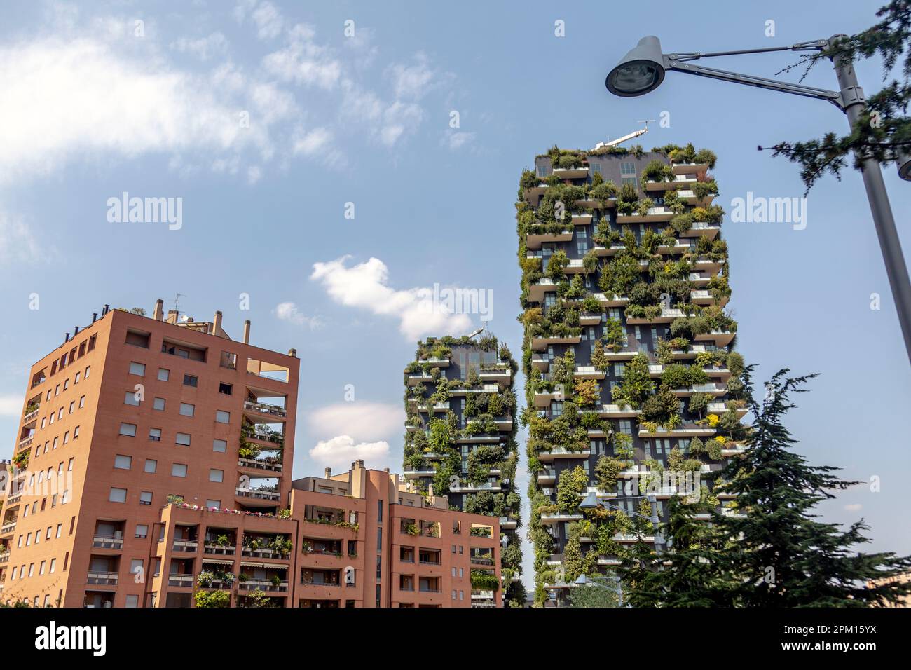 An urban building is transformed by a green facade and thriving plant ...
