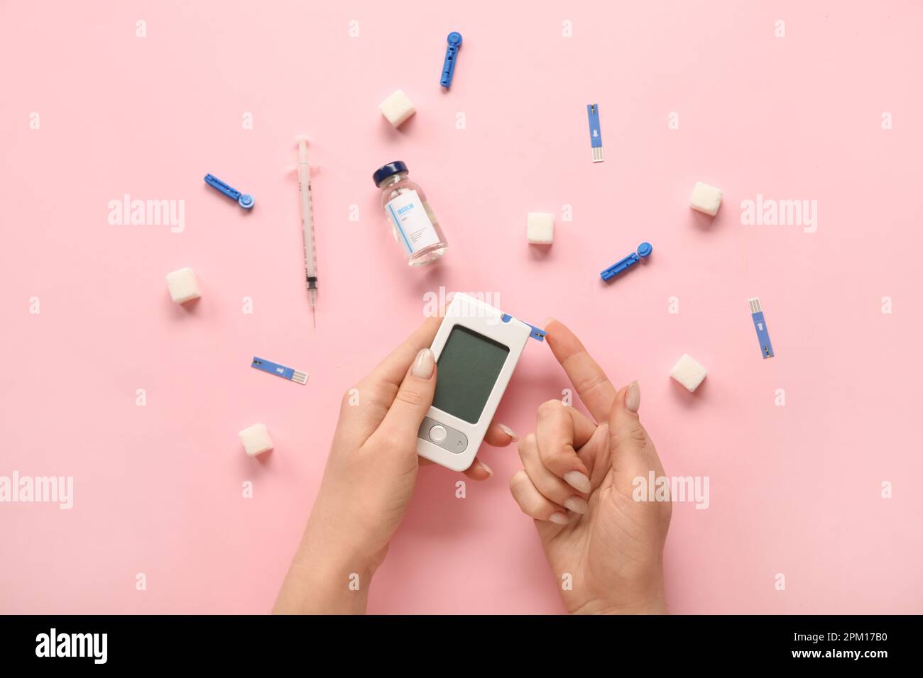 Woman using glucometer on pink background. Diabetes concept Stock Photo ...