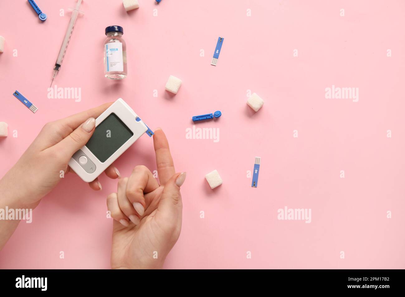 Woman using glucometer on pink background. Diabetes concept Stock Photo ...
