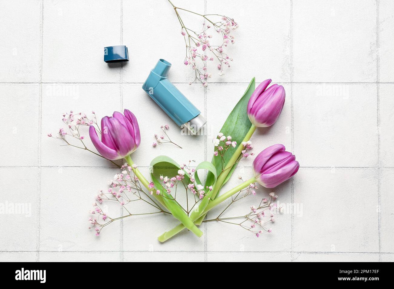 Asthma inhaler with flowers on white tile background Stock Photo - Alamy