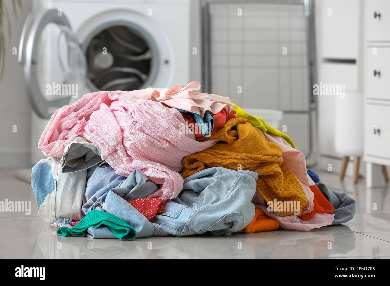 Stack of dirty clothes on floor in laundry room, closeup Stock Photo ...