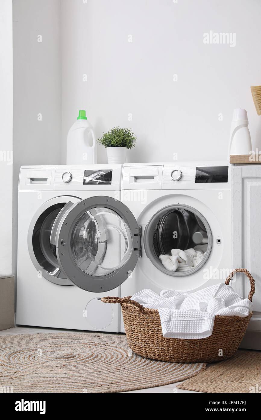 Modern washing machines with dirty clothes in laundry room Stock Photo ...