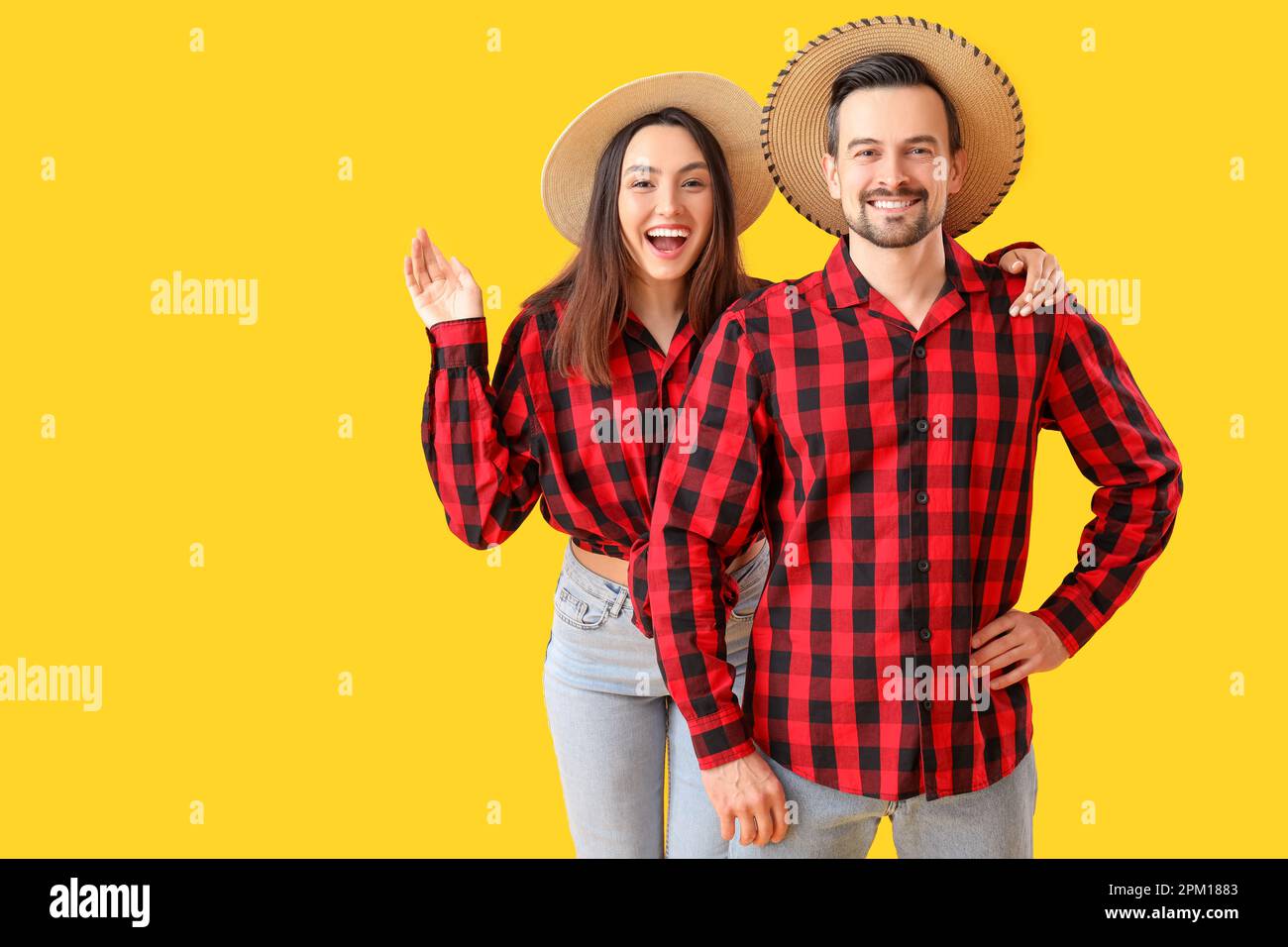 Happy young couple on yellow background. Festa Junina (June Festival ...