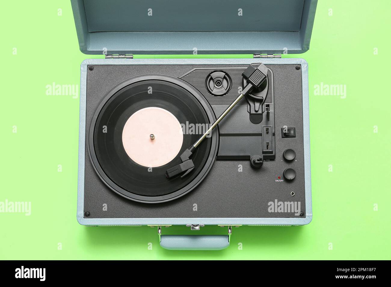 Record player with vinyl disk on green background Stock Photo - Alamy