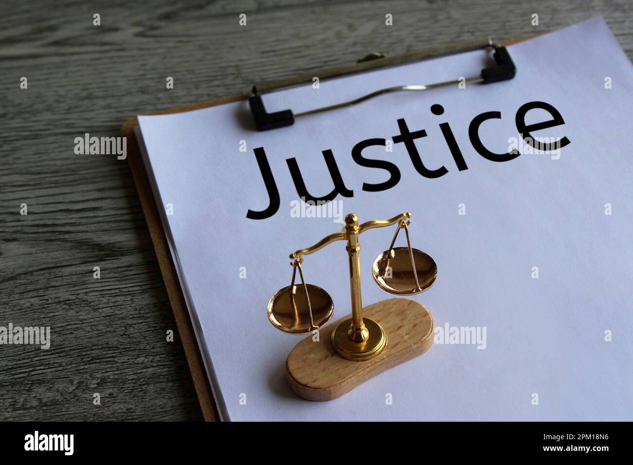 Close up image of balancing scale and text JUSTICE. Legal law and ...