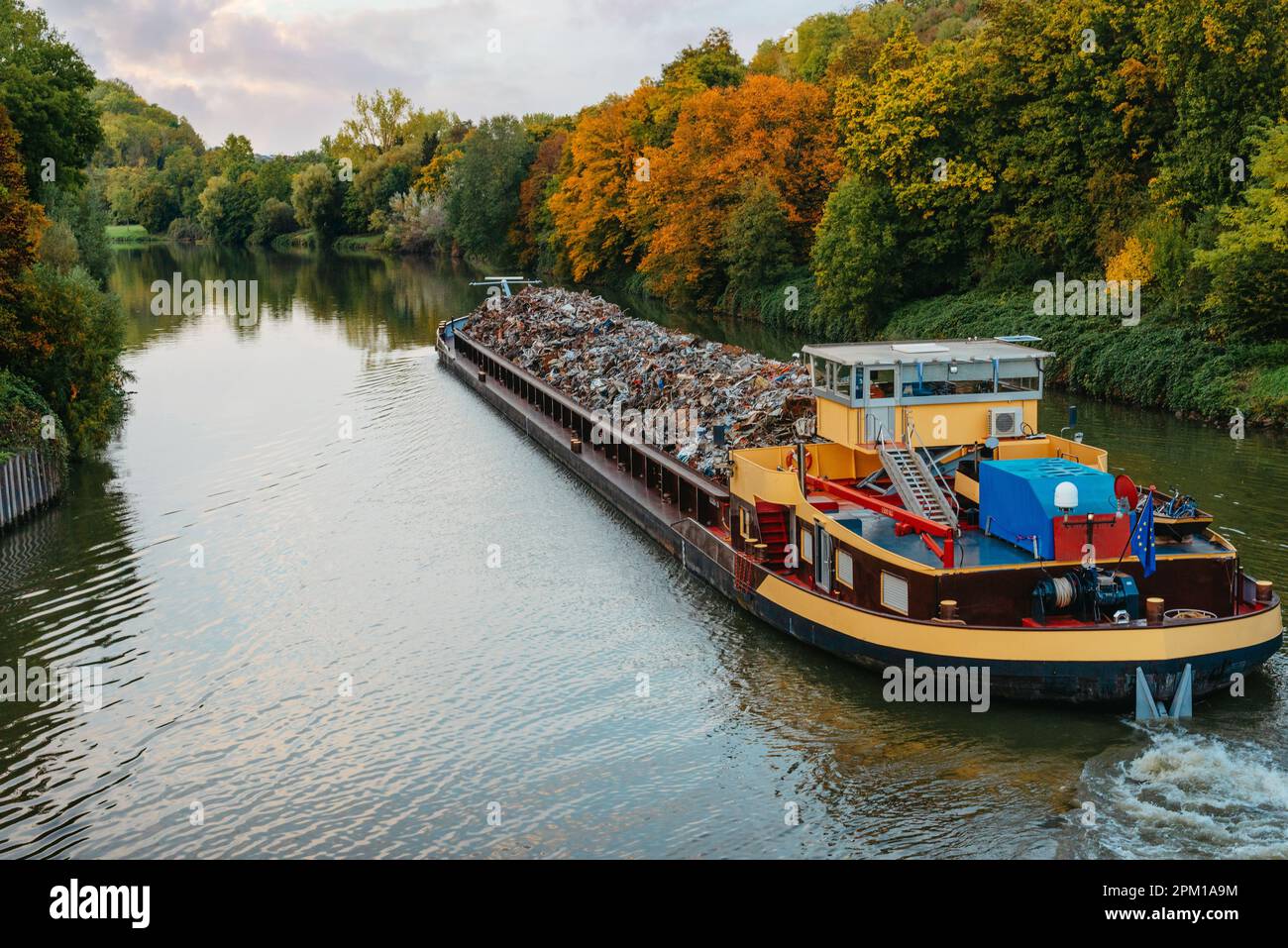 Transportation industry. Ship barge transports scrap metal and sand ...