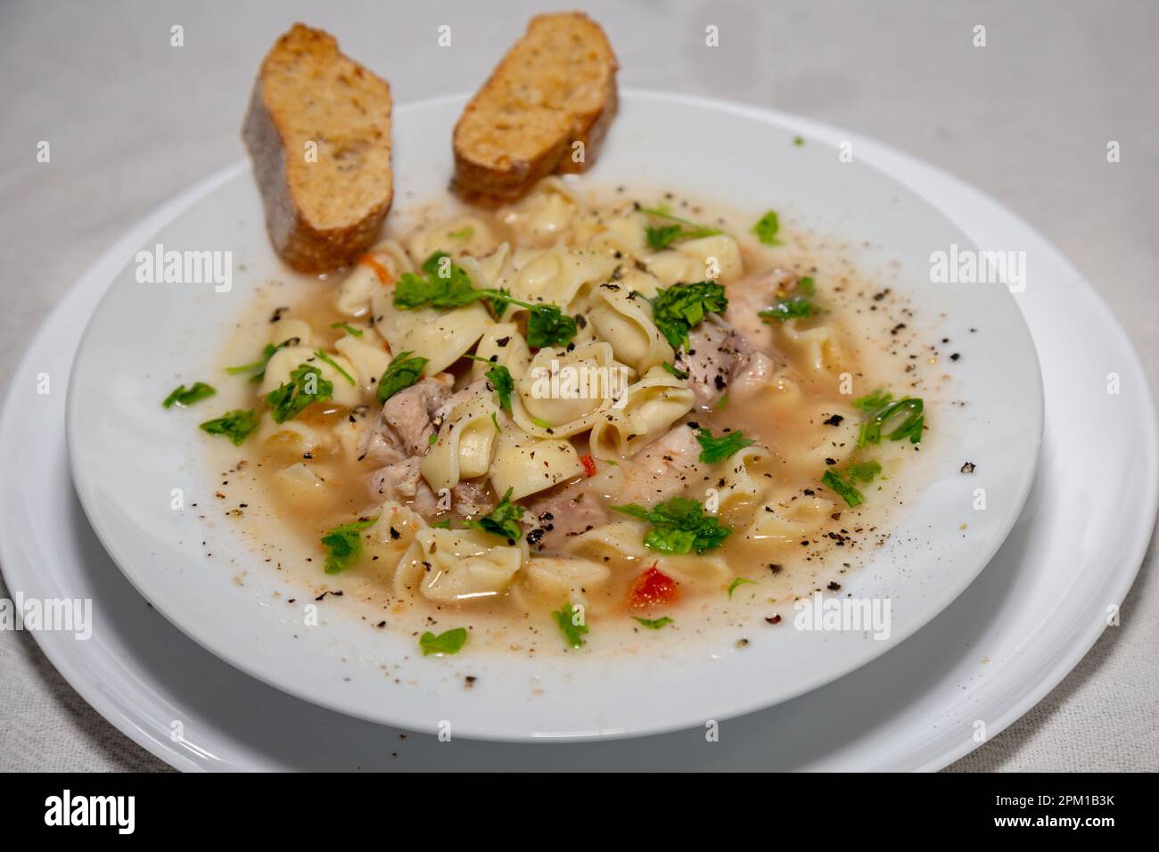 Traditional chicken agnolini (capeletti) soup. winter soup Stock Photo ...