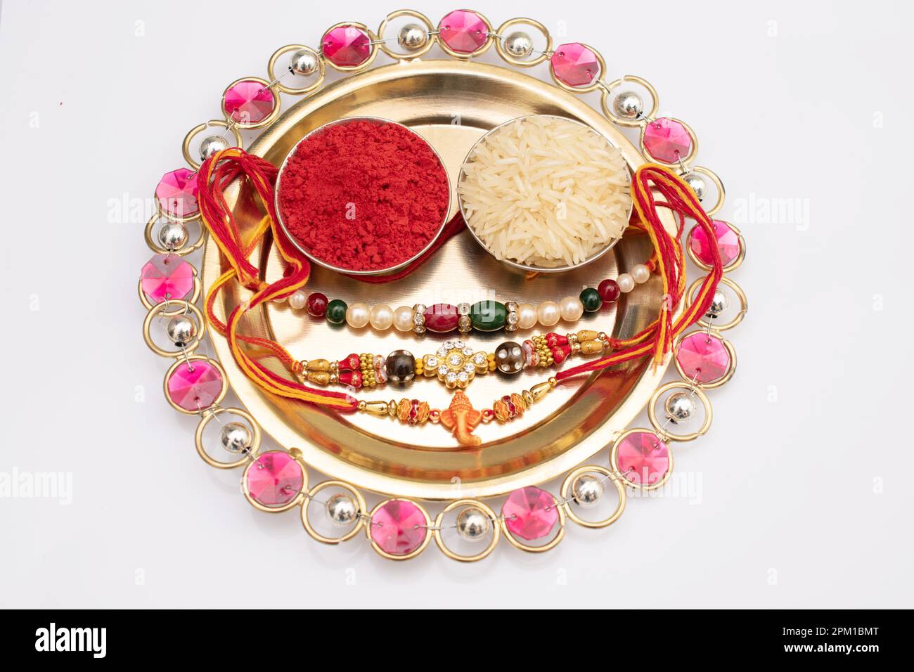 Rakhi with roli and chawal on white background Stock Photo - Alamy