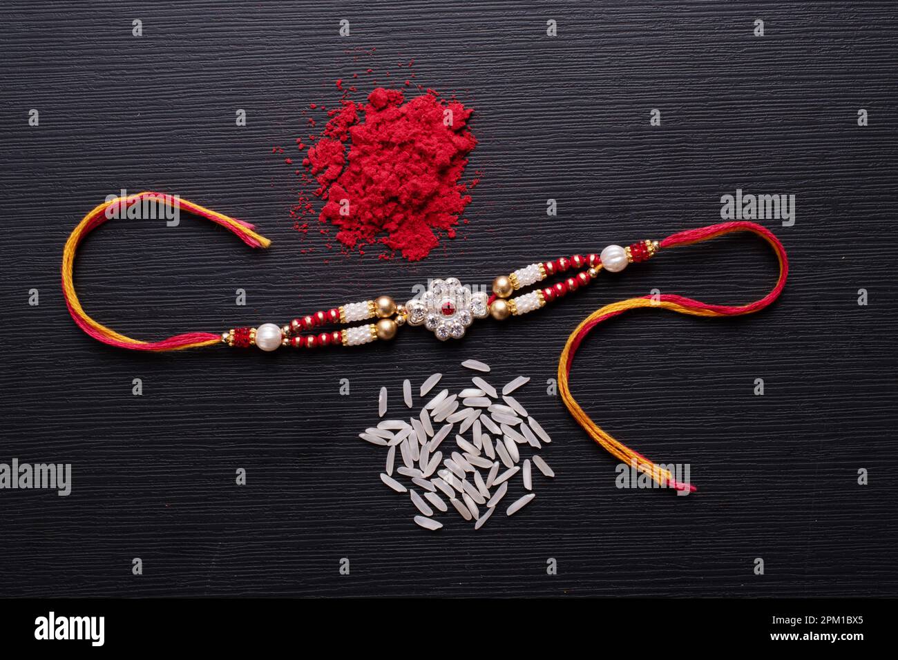 Top view of rakhi with kumkum and rice for raksha bandhan Stock Photo ...