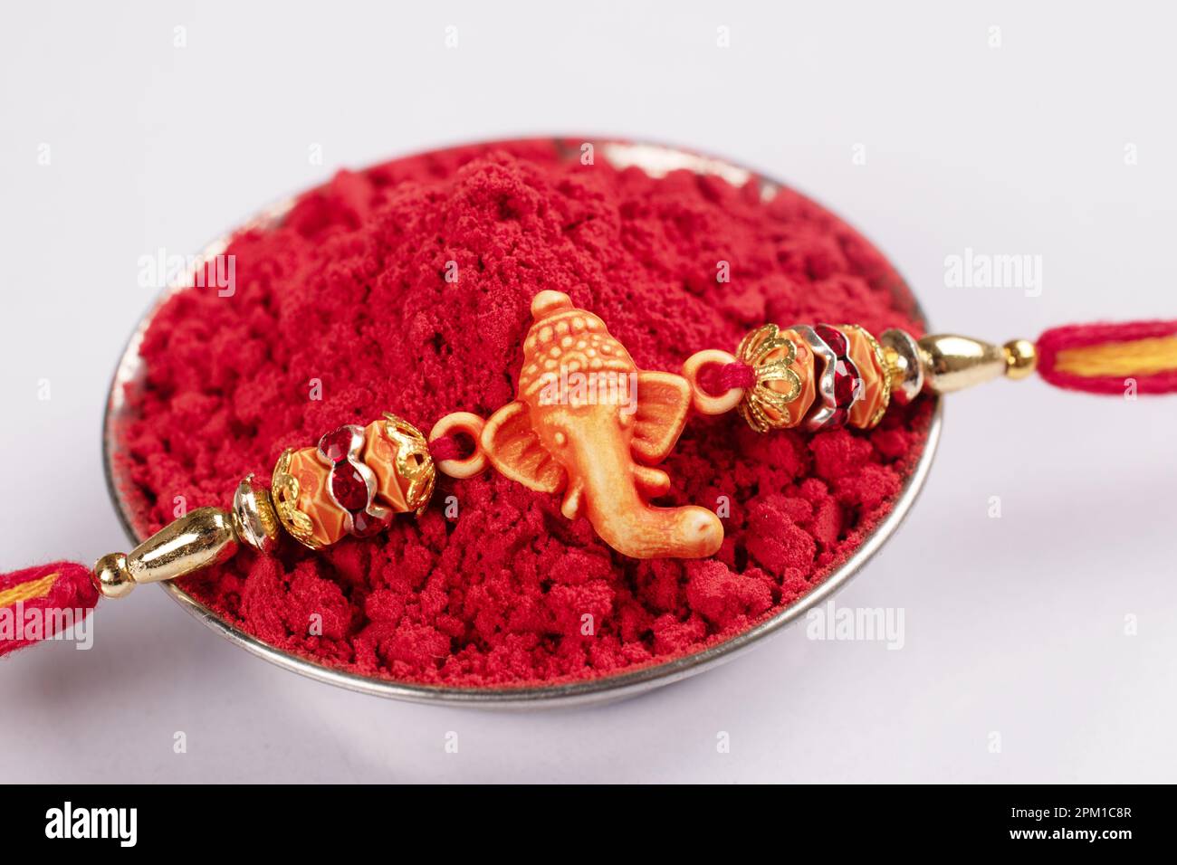 Small ganesh rakhi with kumkum on white background Stock Photo - Alamy