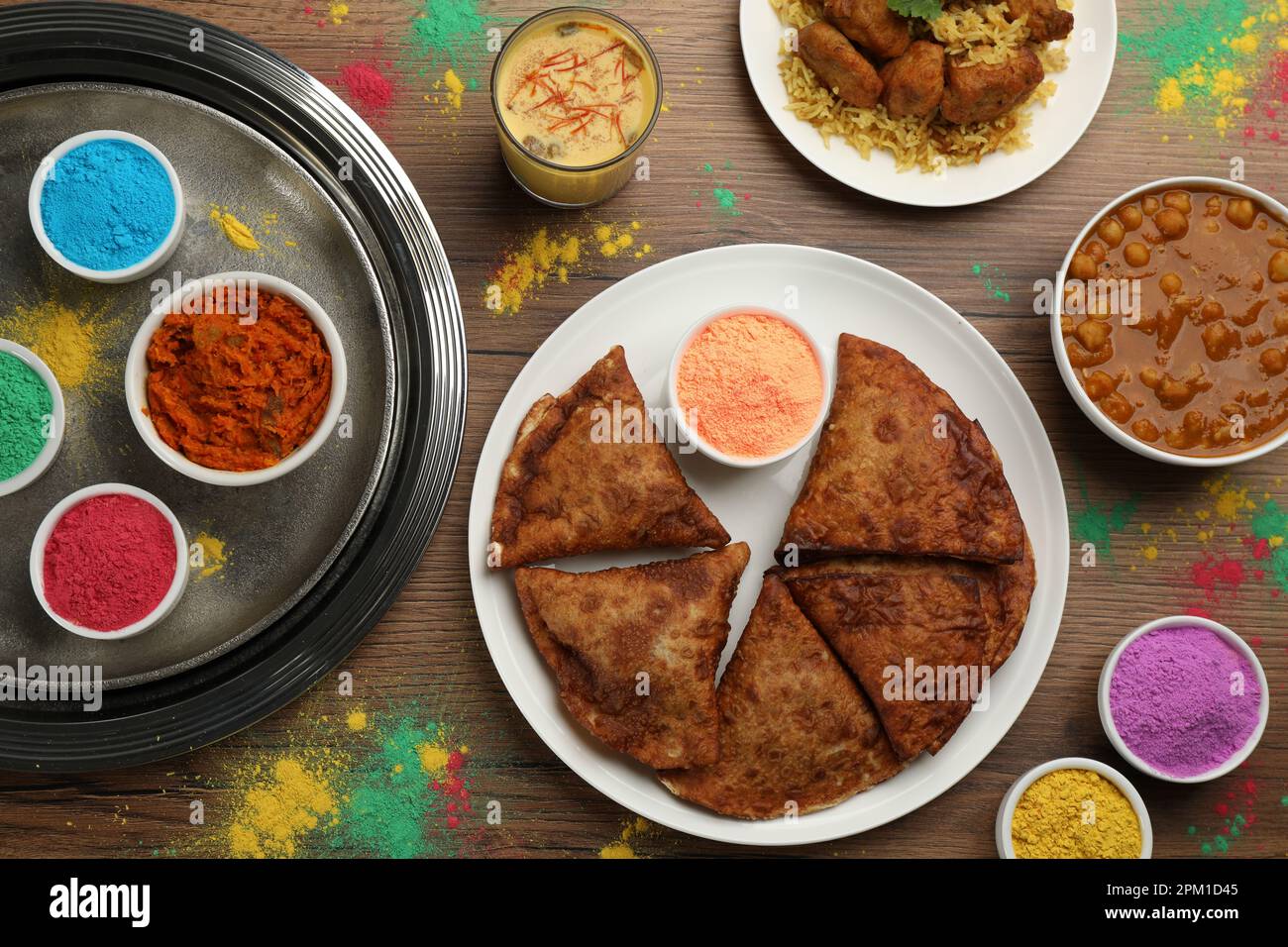 Traditional Indian food and color powders on wooden table, flat lay ...