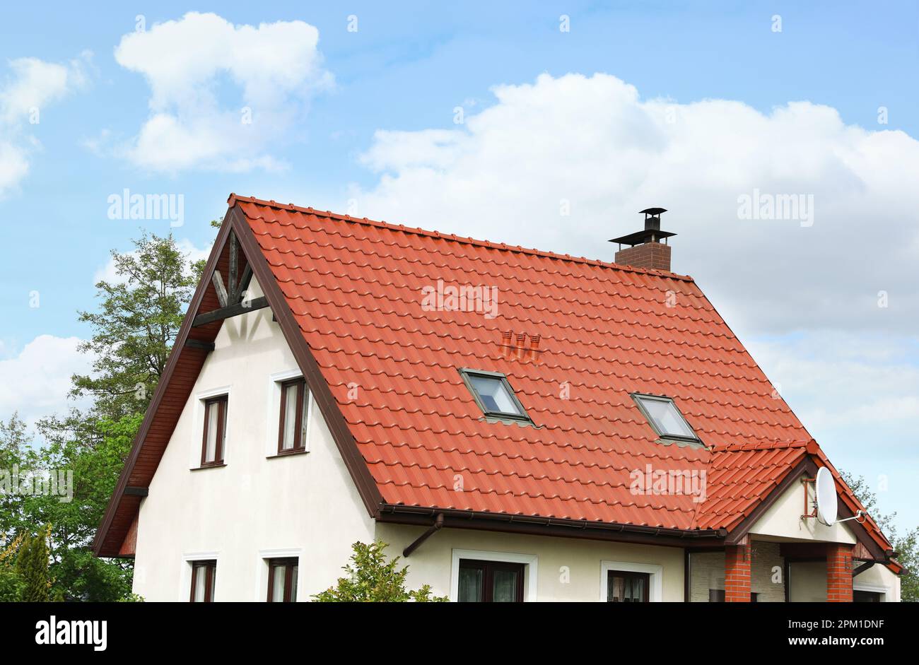 Modern house with red roof against blue sky Stock Photo - Alamy