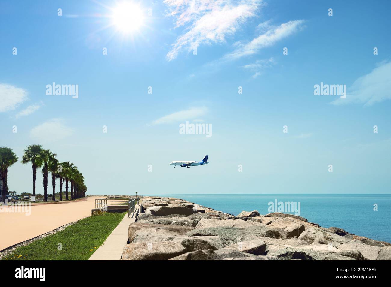 Modern airplane flying in sky over sea Stock Photo - Alamy