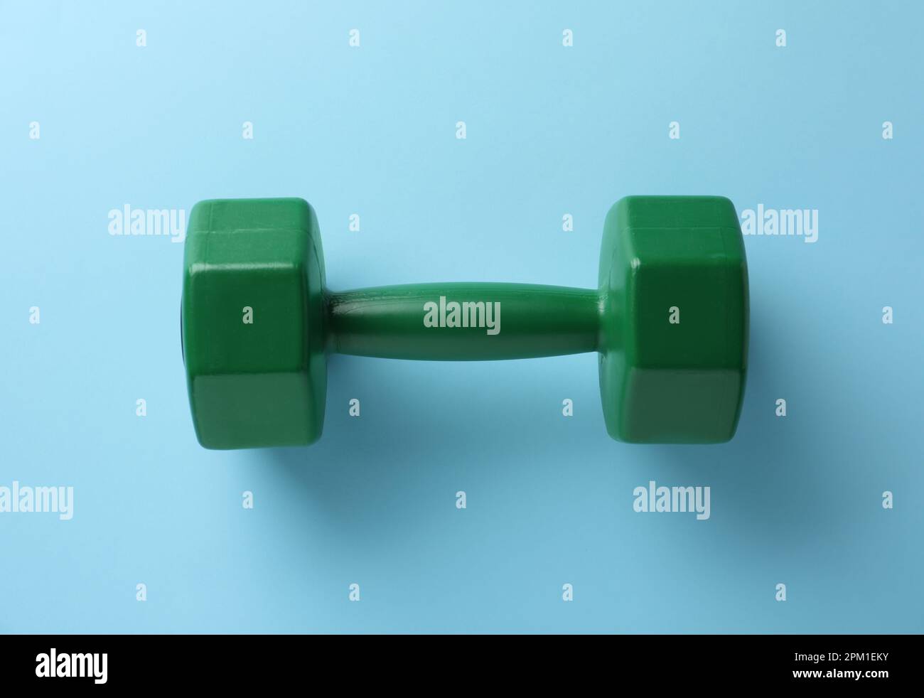 Stylish dumbbell on light blue background, top view Stock Photo - Alamy