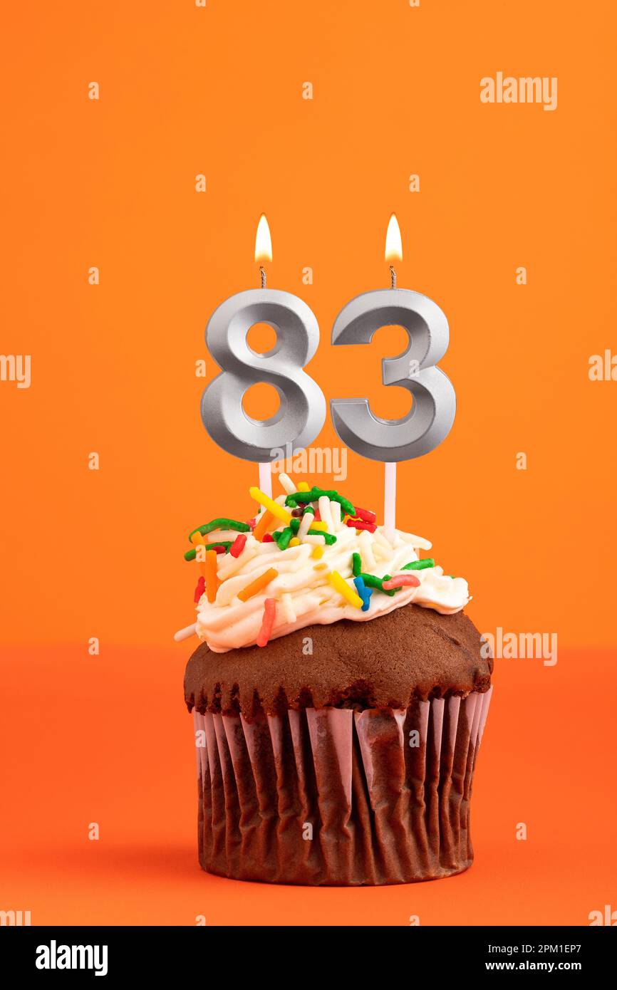 Candle number 83 - Cake birthday in orange background Stock Photo - Alamy