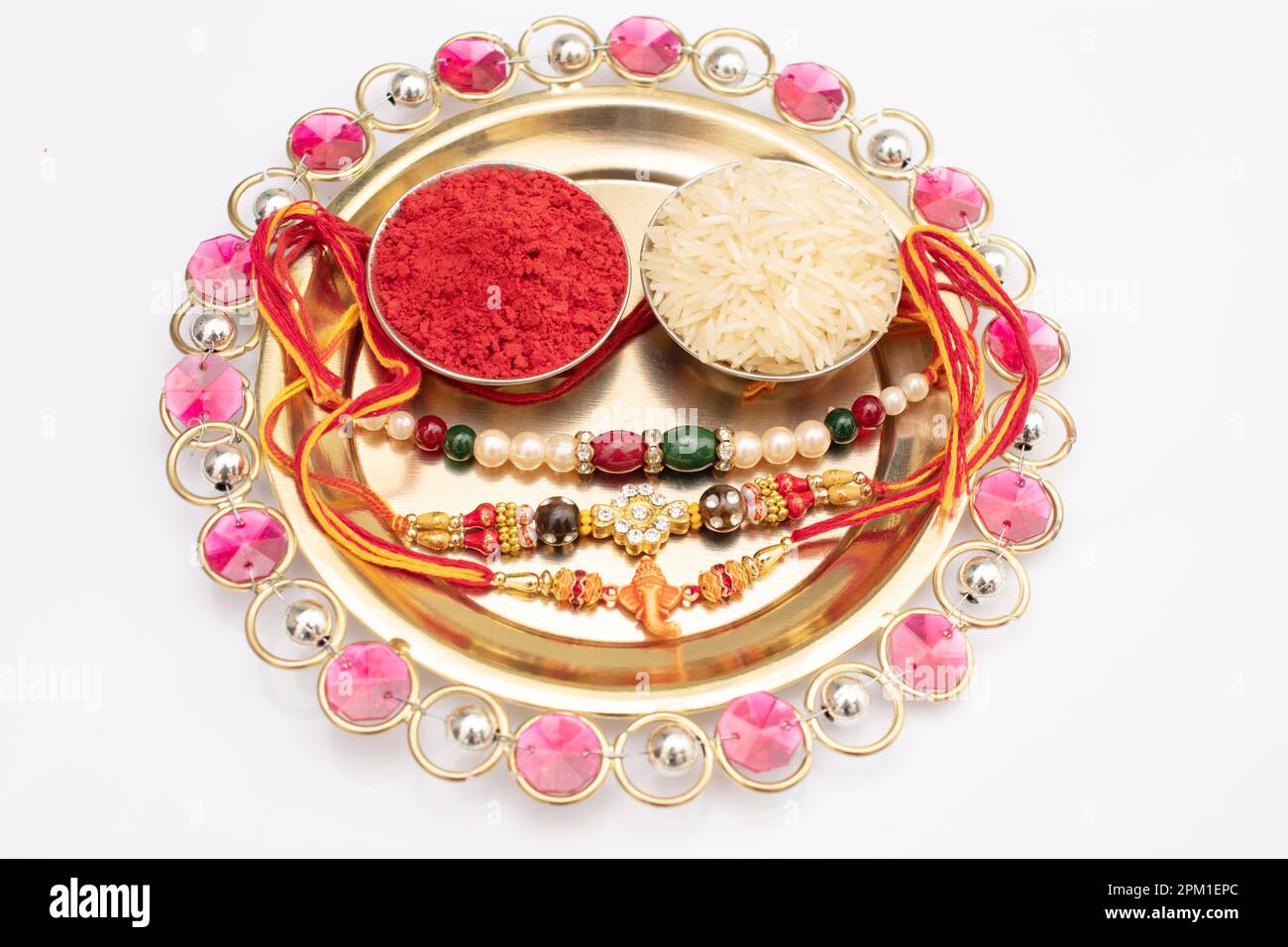 Rakhi with kumkum and rice isolated on white background Stock Photo - Alamy