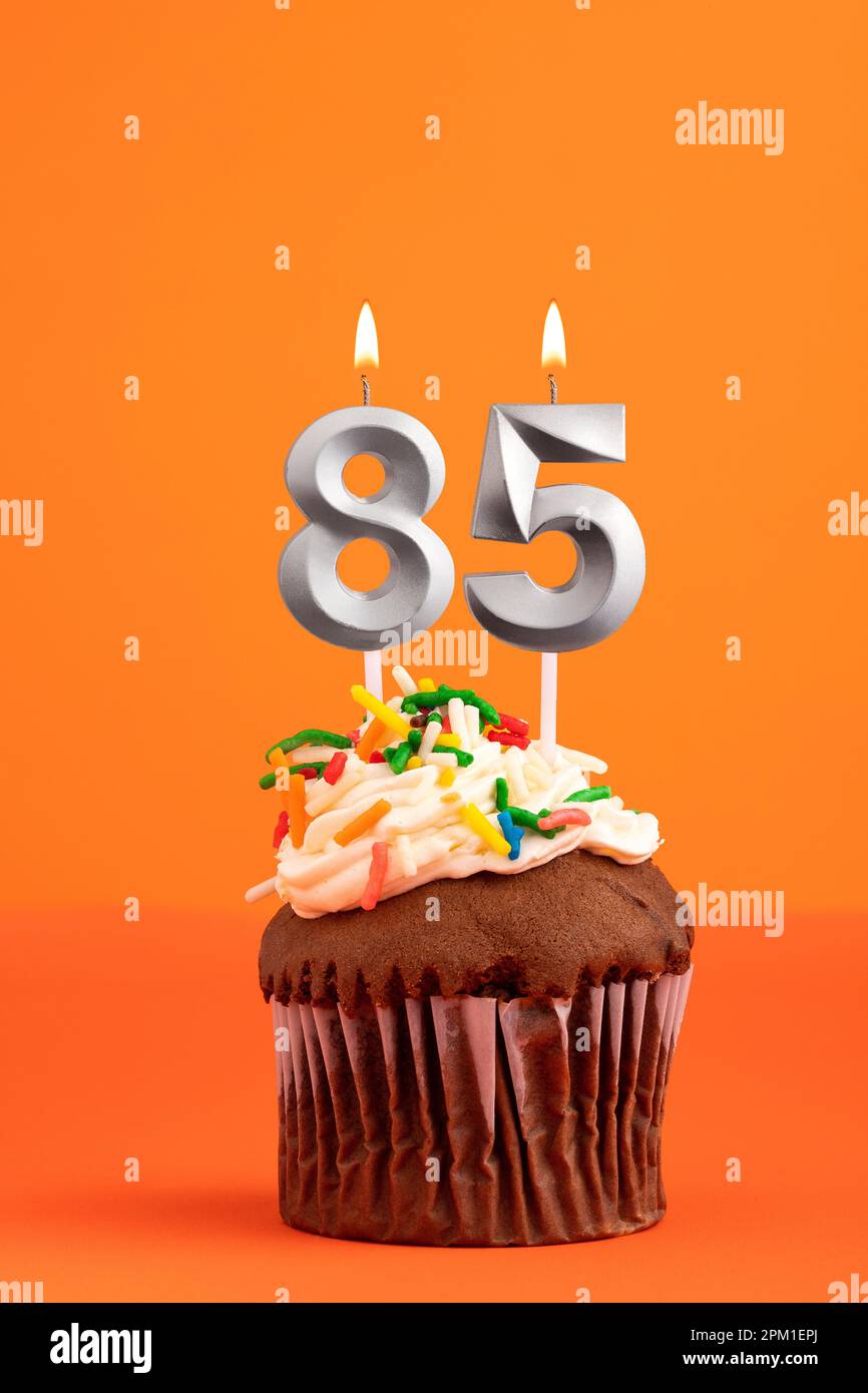 Candle number 85 - Cake birthday in orange background Stock Photo - Alamy