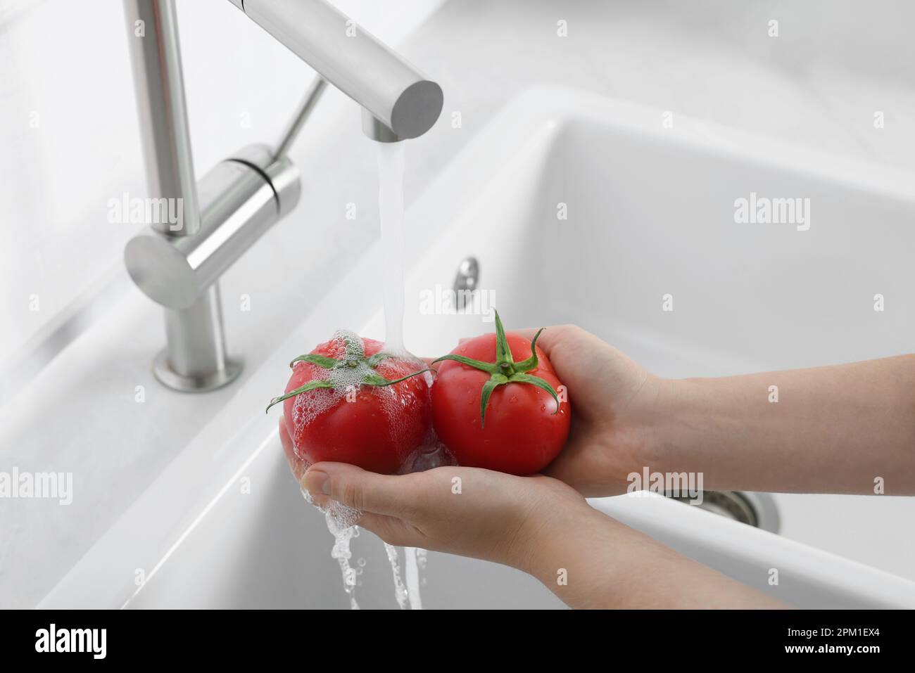 Woman washing fresh vegetables under hi-res stock photography and images - Alamy