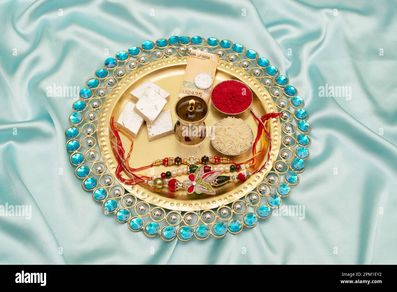 Rakhi with sweets and diya roli pooja thali Stock Photo - Alamy