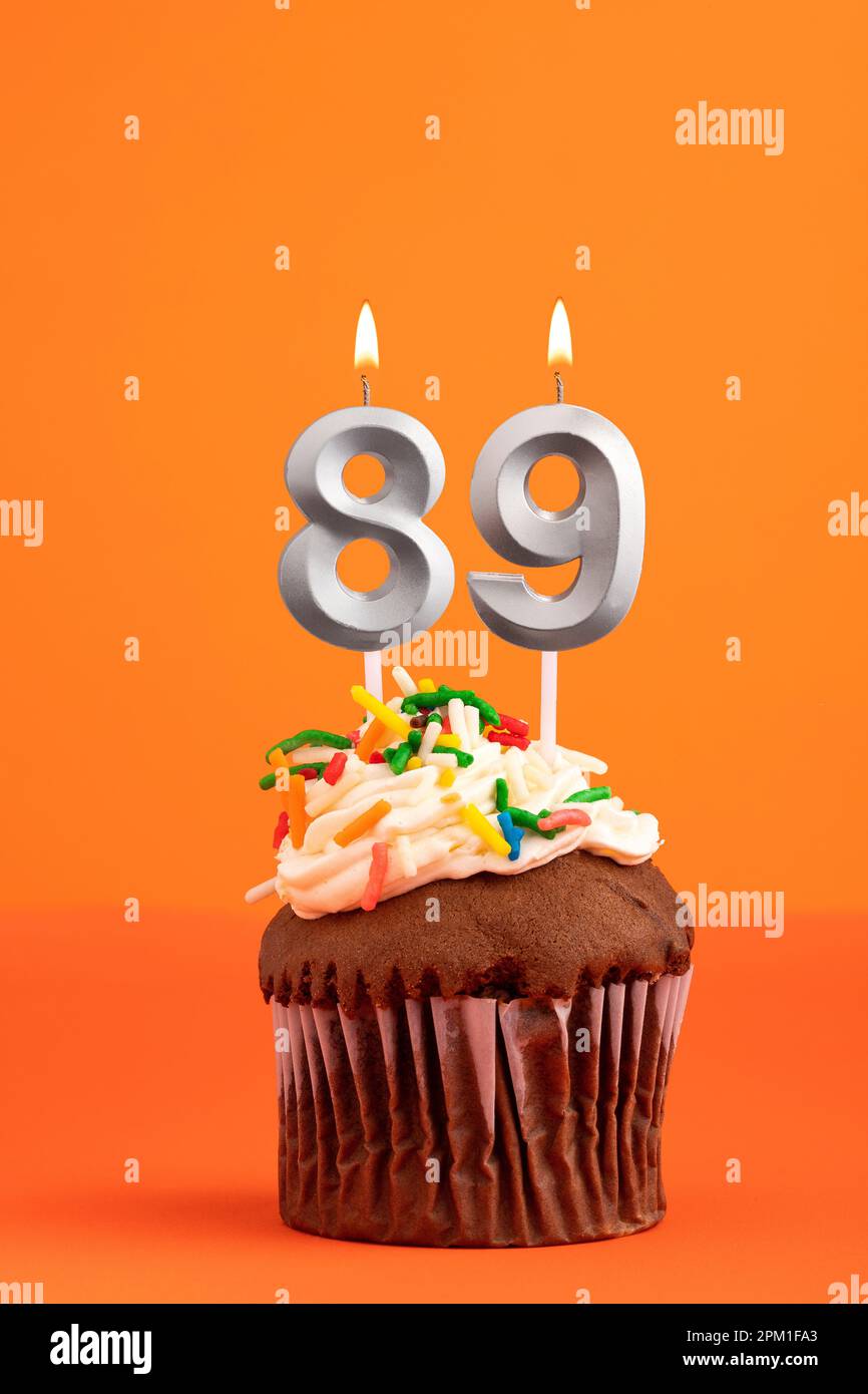 Candle number 89 - Cake birthday in orange background Stock Photo - Alamy