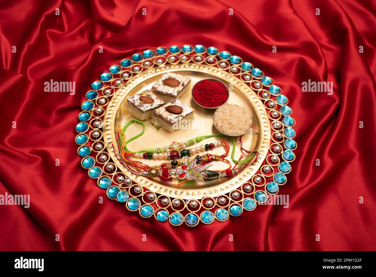Rakhi with kumkum and sweet in pooja thali Stock Photo - Alamy